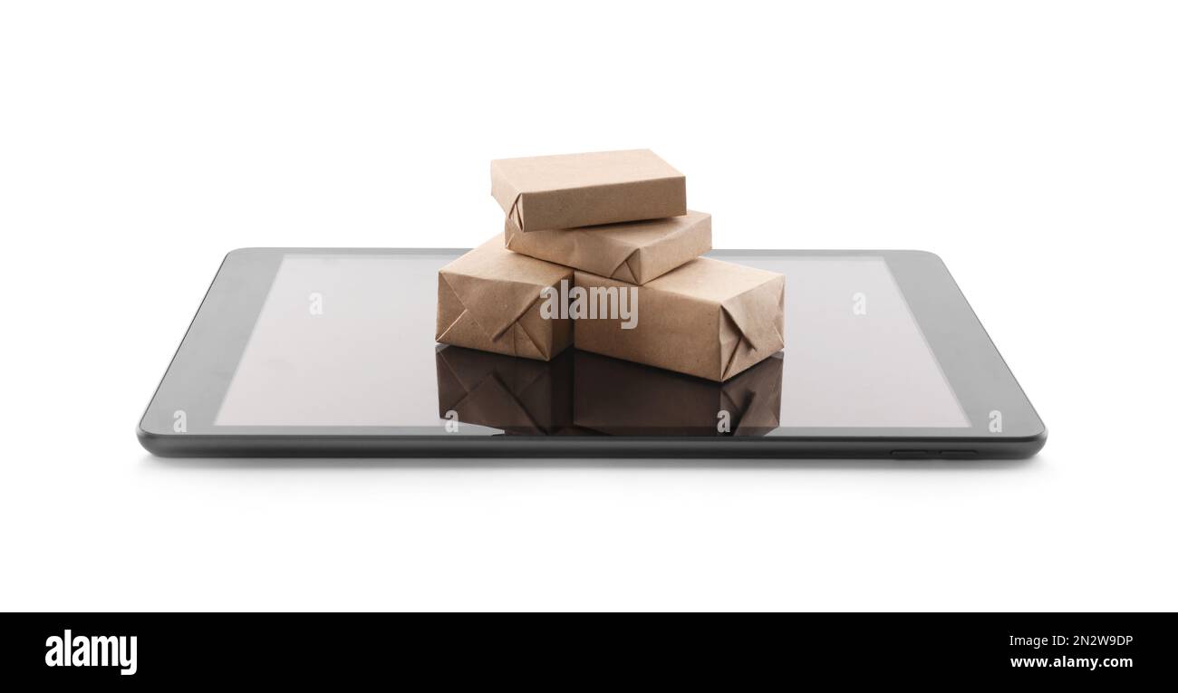 Internet shopping. Small boxes and modern tablet on white background ...