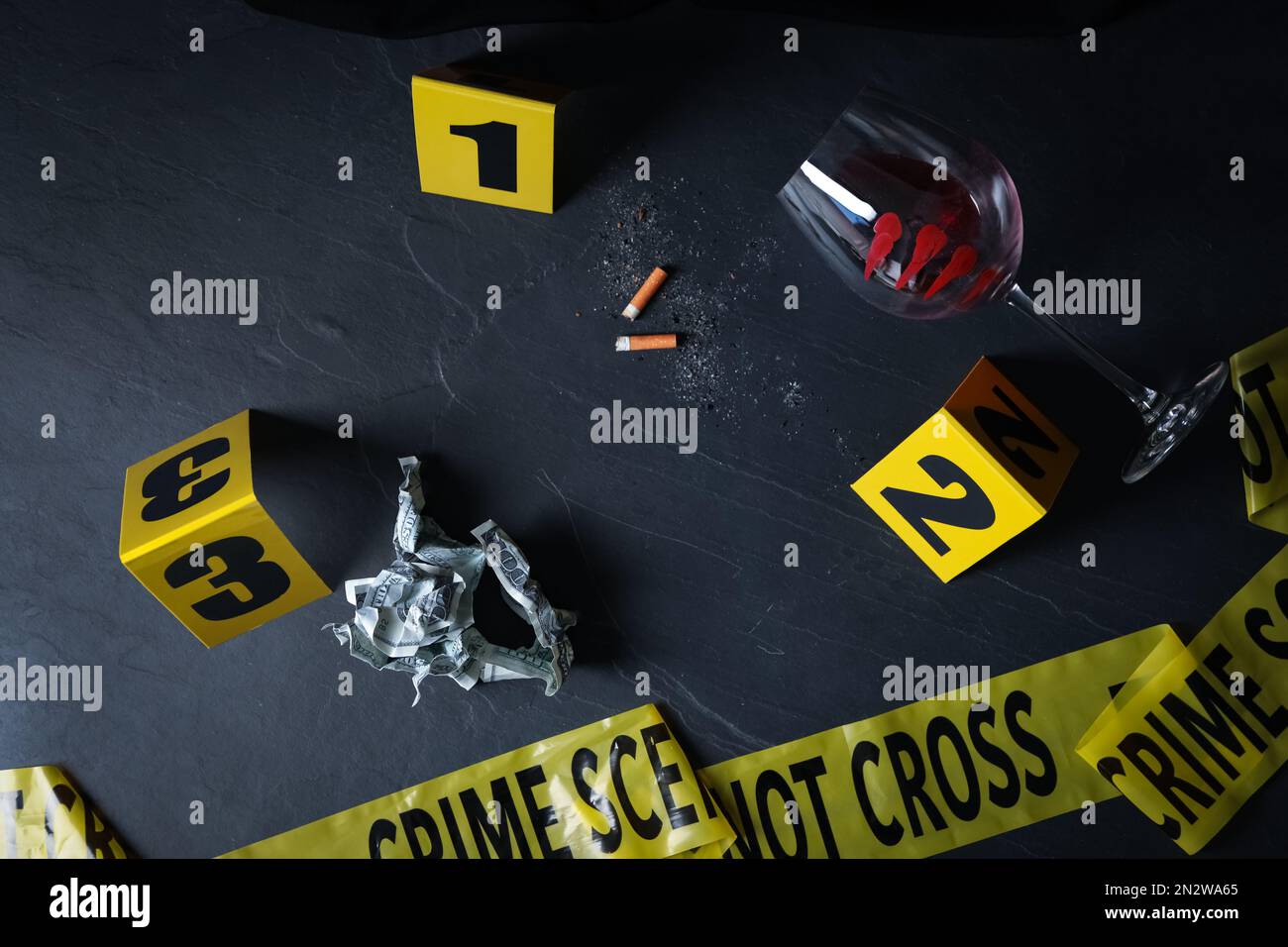 Flat lay composition with evidences and crime scene markers on black ...