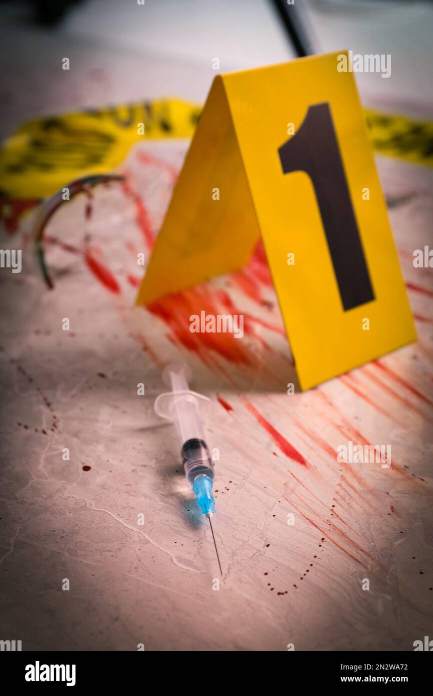 Syringe in blood and crime scene marker on marble table, closeup Stock ...