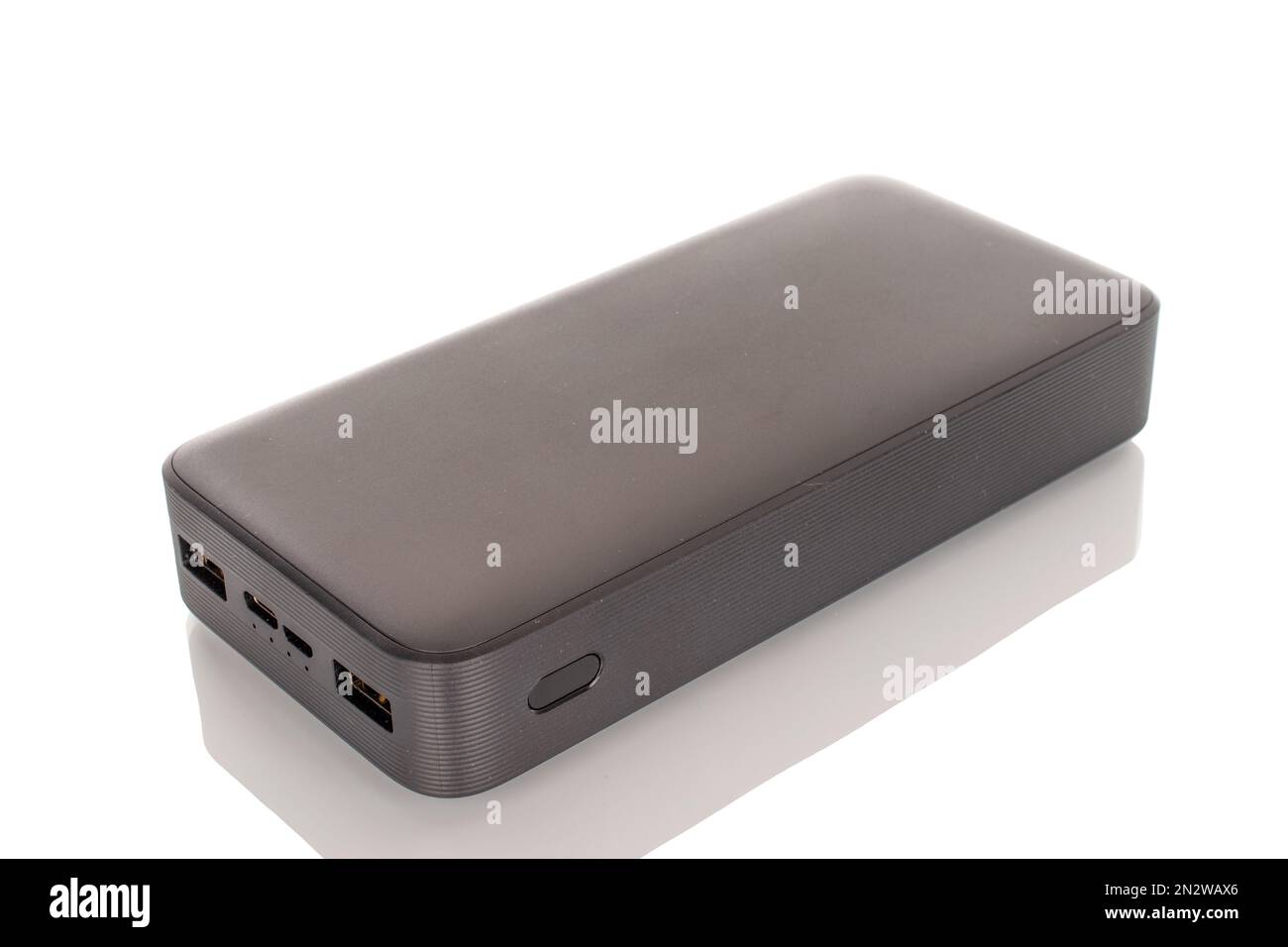 One black portable power bank charger, close-up isolated on white ...