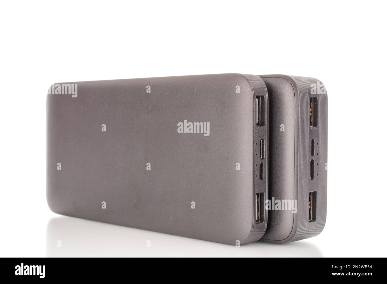 Two black portable power bank chargers with red paper box, close-up ...