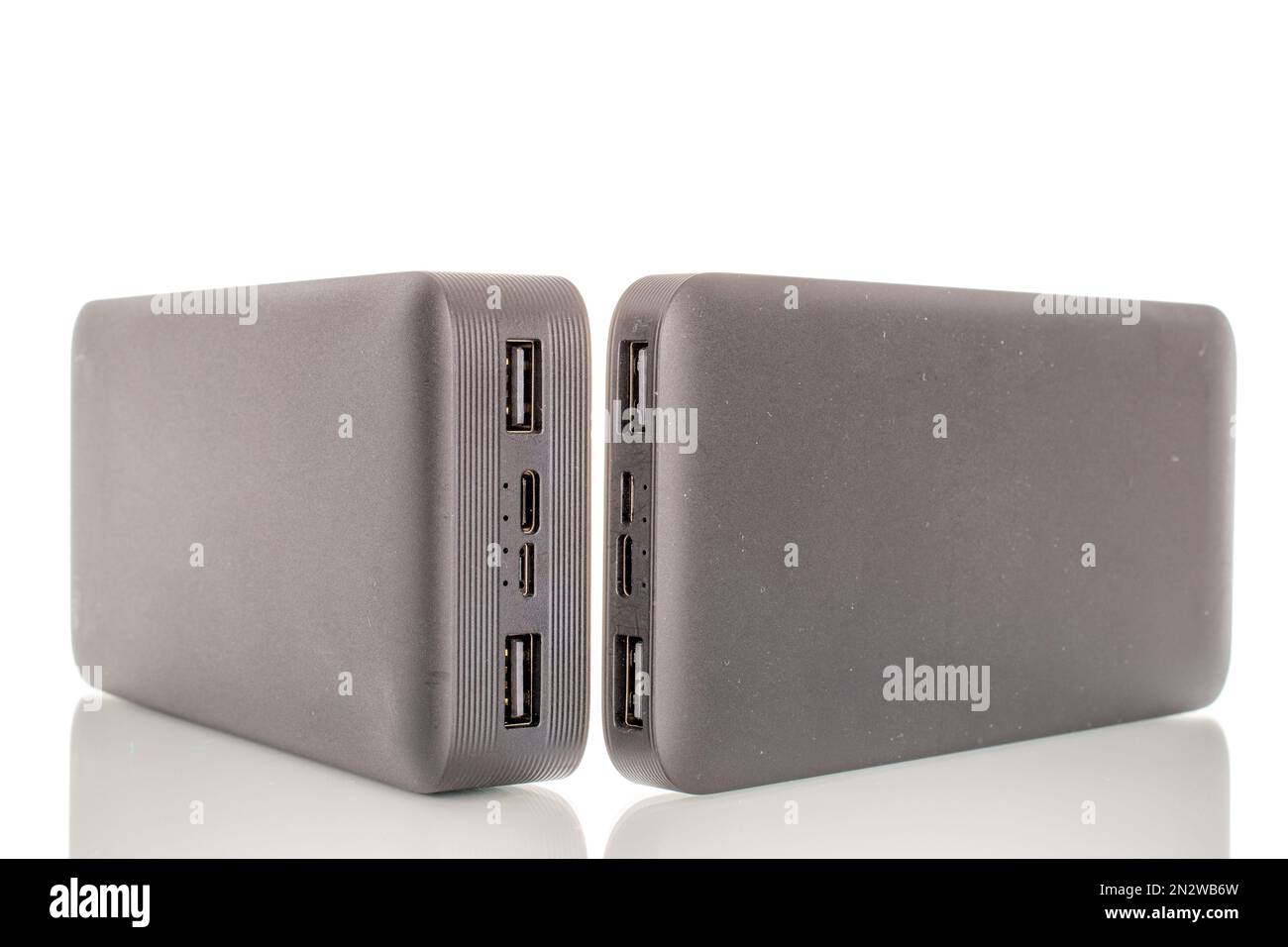 Two black portable power bank chargers with red paper box, close-up ...