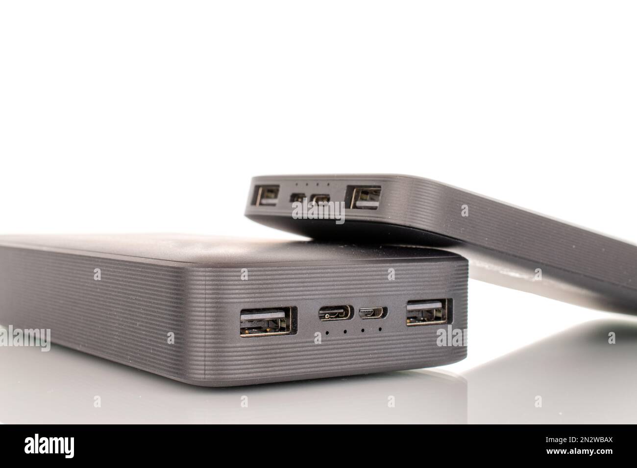 Two black portable power bank chargers with red paper box, close-up ...