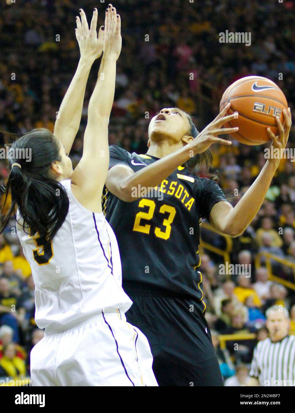 Minnesota guard Shae Kelley (23) goes to the basket against Iowa ...