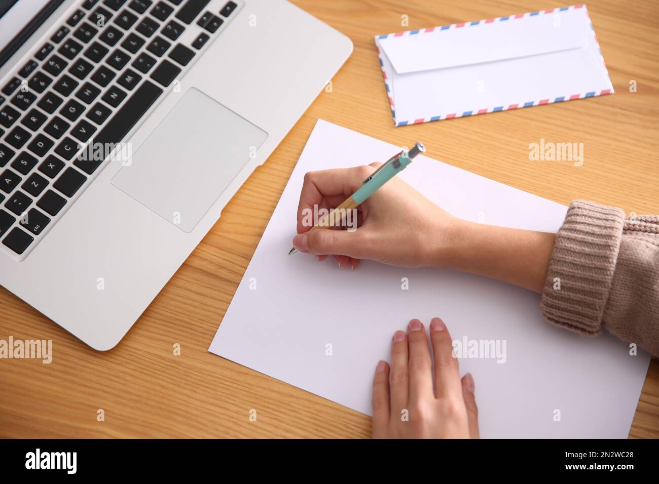 Woman writing letter at wooden table, above view Stock Photo - Alamy