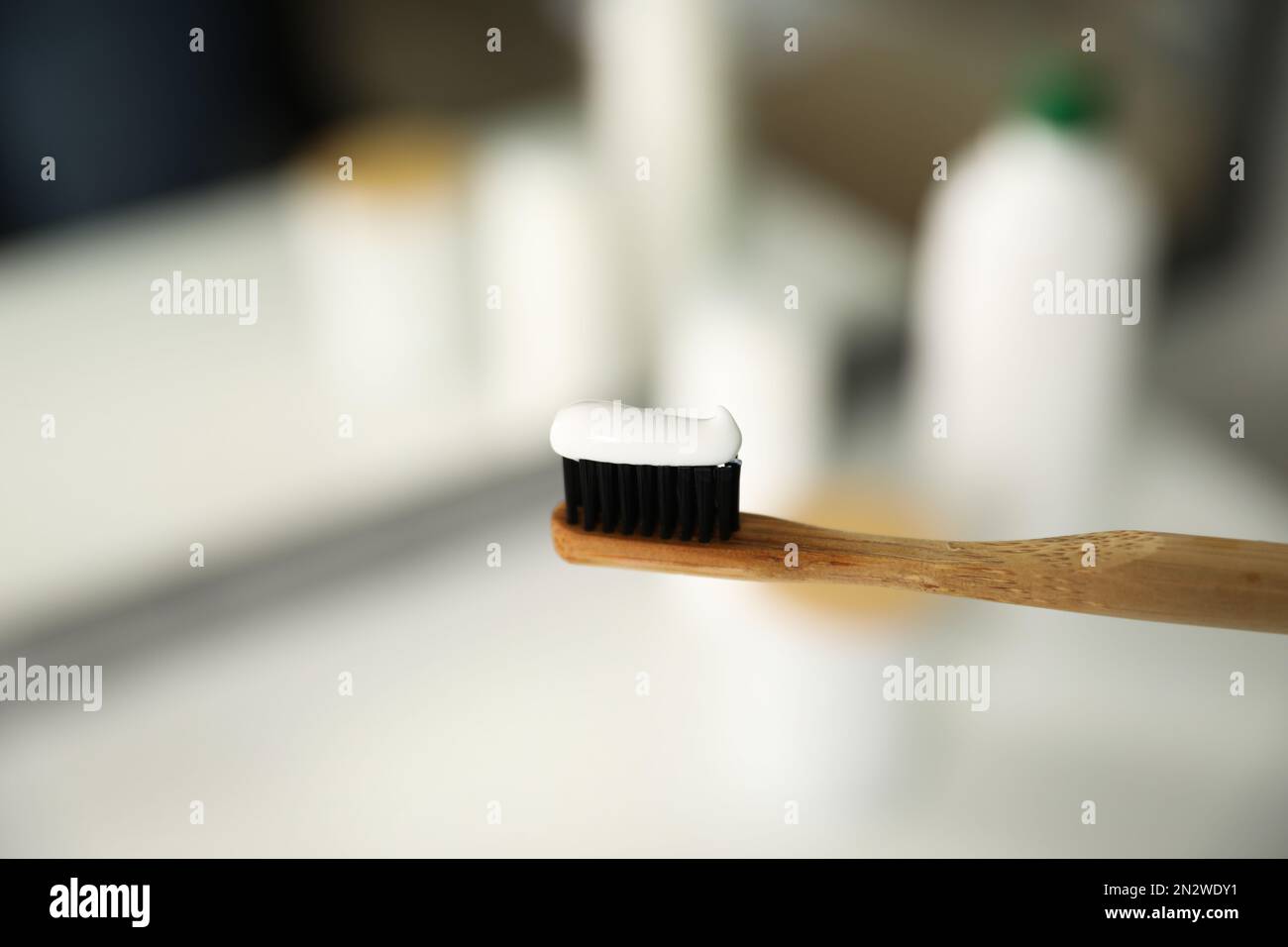 Toothbrush with paste on blurred background, closeup Stock Photo - Alamy