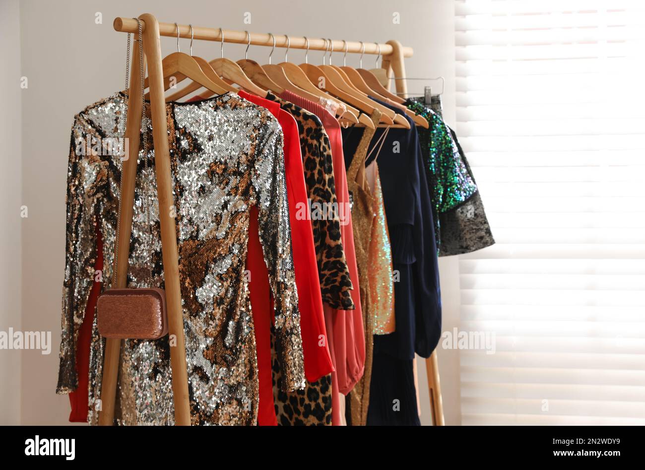 Rack with stylish women's clothes indoors. Interior design Stock Photo ...