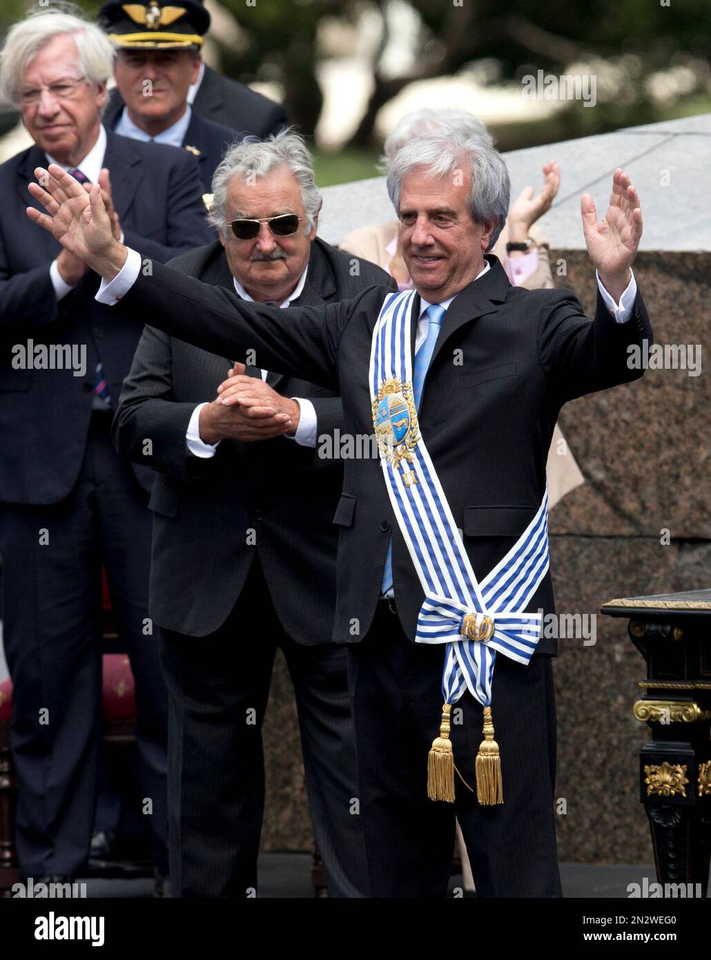Uruguay's new President Tabare Vazquez waves to the crowed wearing the presidential sash as ...