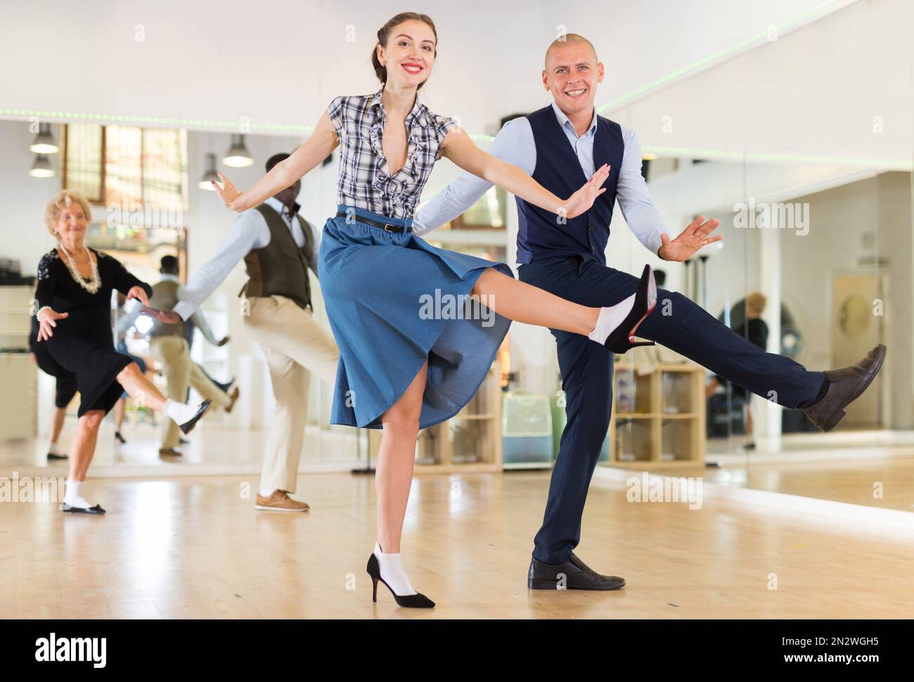 Adult dancing couple enjoying active swing Stock Photo - Alamy