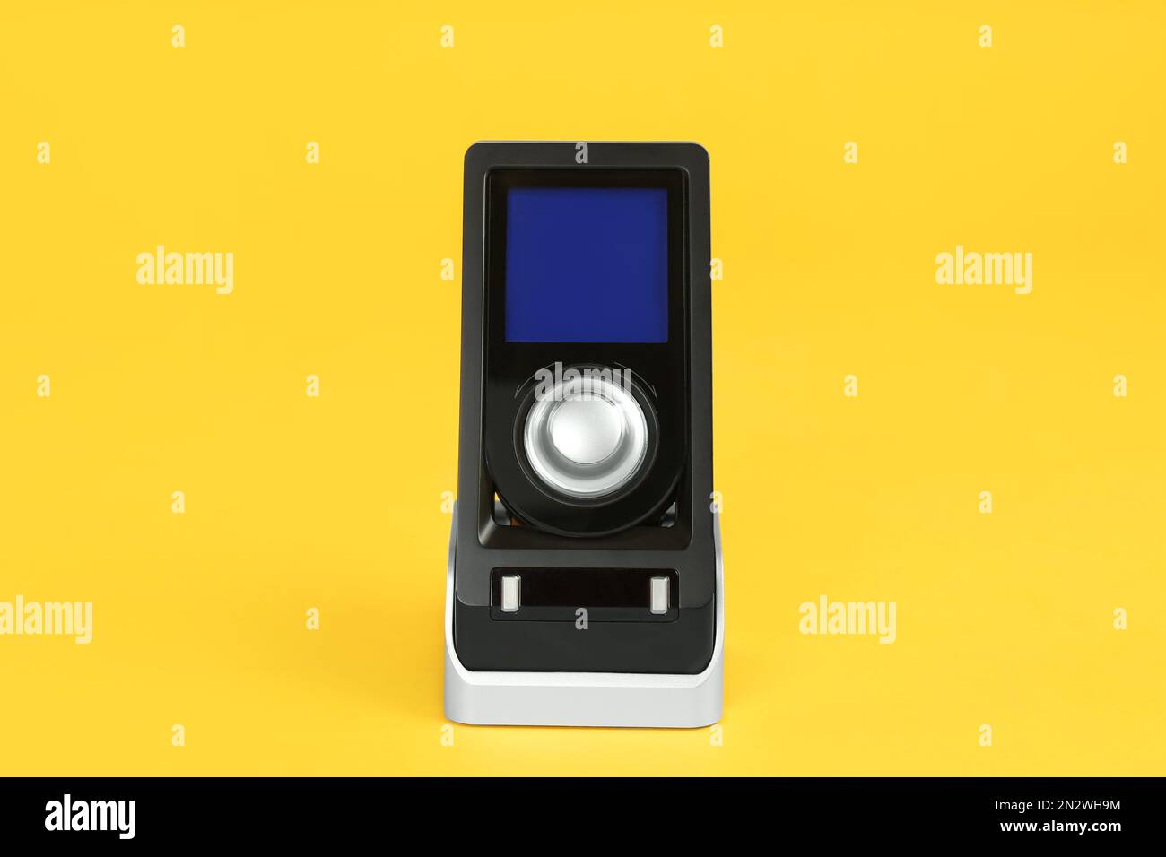 Modern remote for audio speakers on yellow background Stock Photo - Alamy