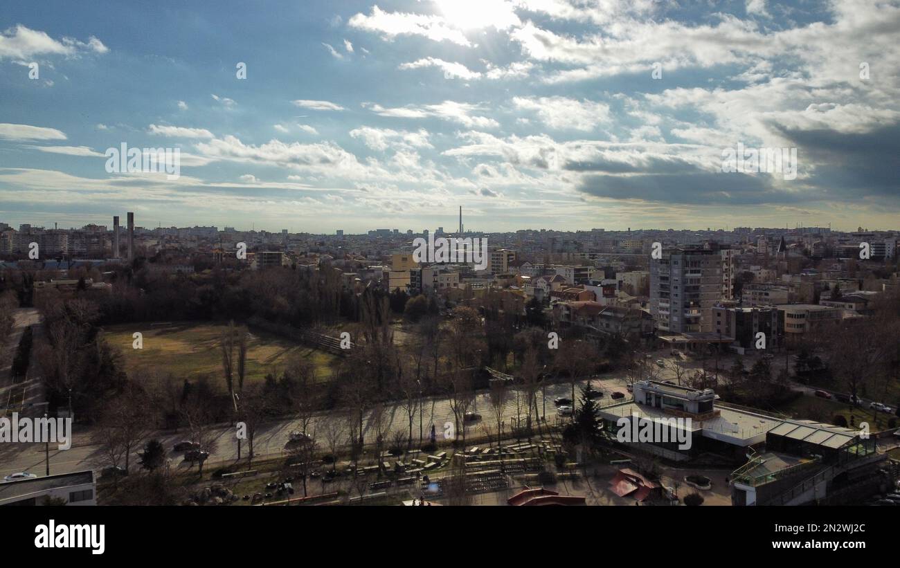 An aerial view of town with dry trees under blue cloudy sky Stock Photo ...