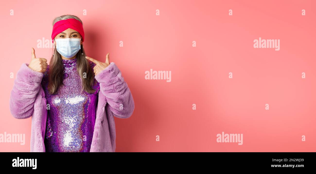 Covid-19, social distancing and fashion concept. Smiling asian senior ...