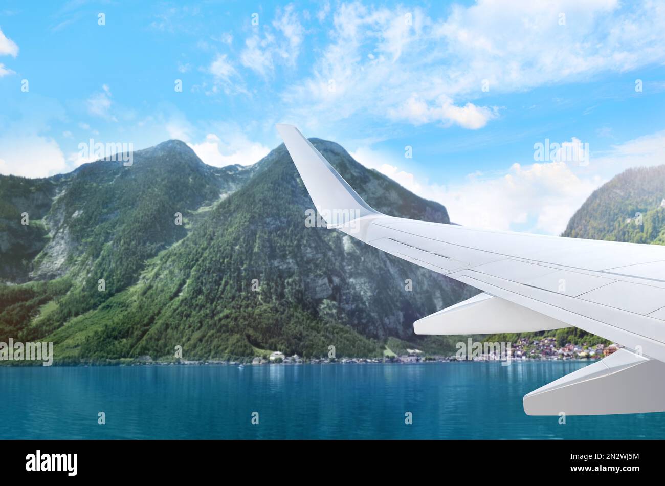 Airplane landing on tropical island, view from porthole Stock Photo - Alamy
