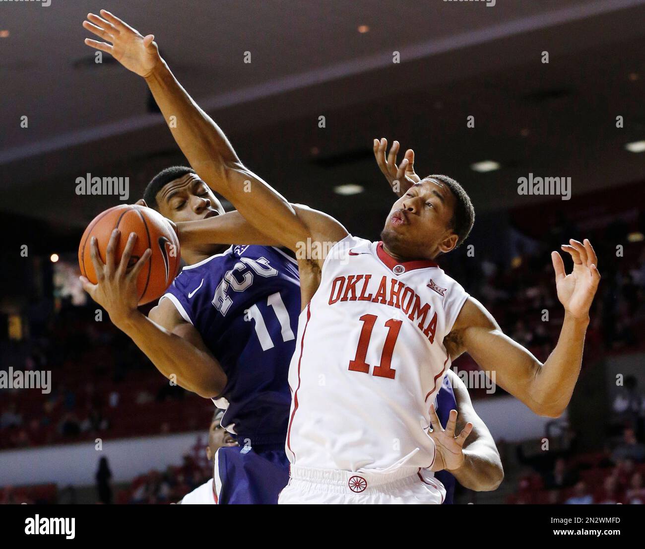 TCU forward Brandon Parrish (11) grabs a rebound behind Oklahoma guard ...