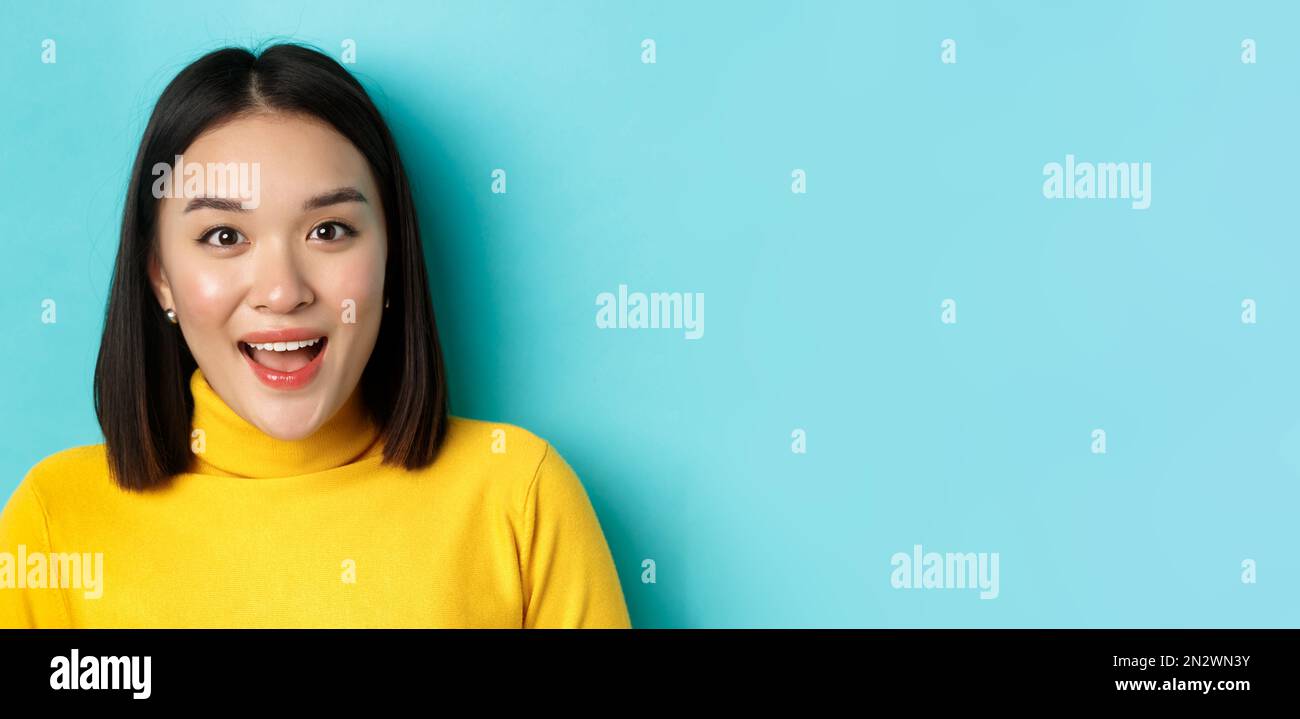 Beauty and skincare concept. Close up of surprised asian female raising ...