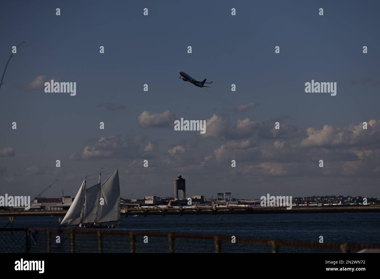 Airplane over Boston harbor Stock Photo - Alamy