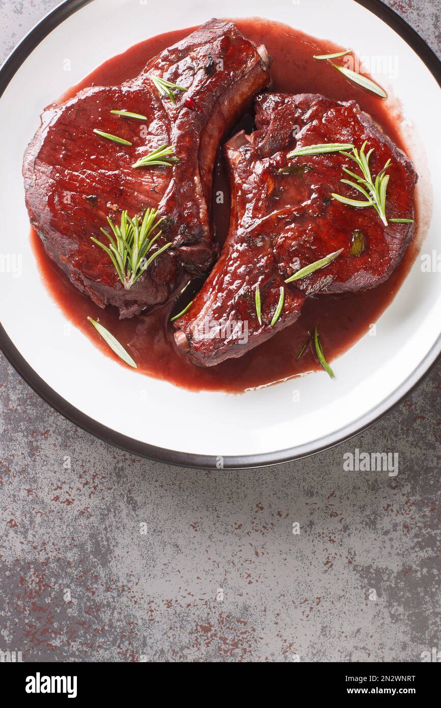 Pork chops on the bone fried and then cooked with red wine, herbs and ...