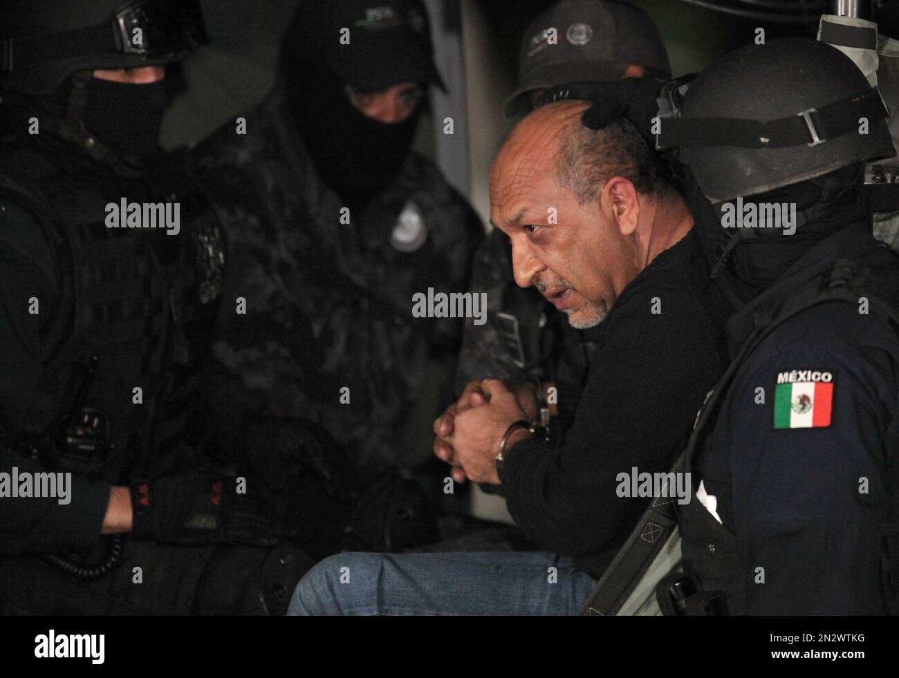 Federal police escort who they identify as Servando "La Tuta" Gomez ...