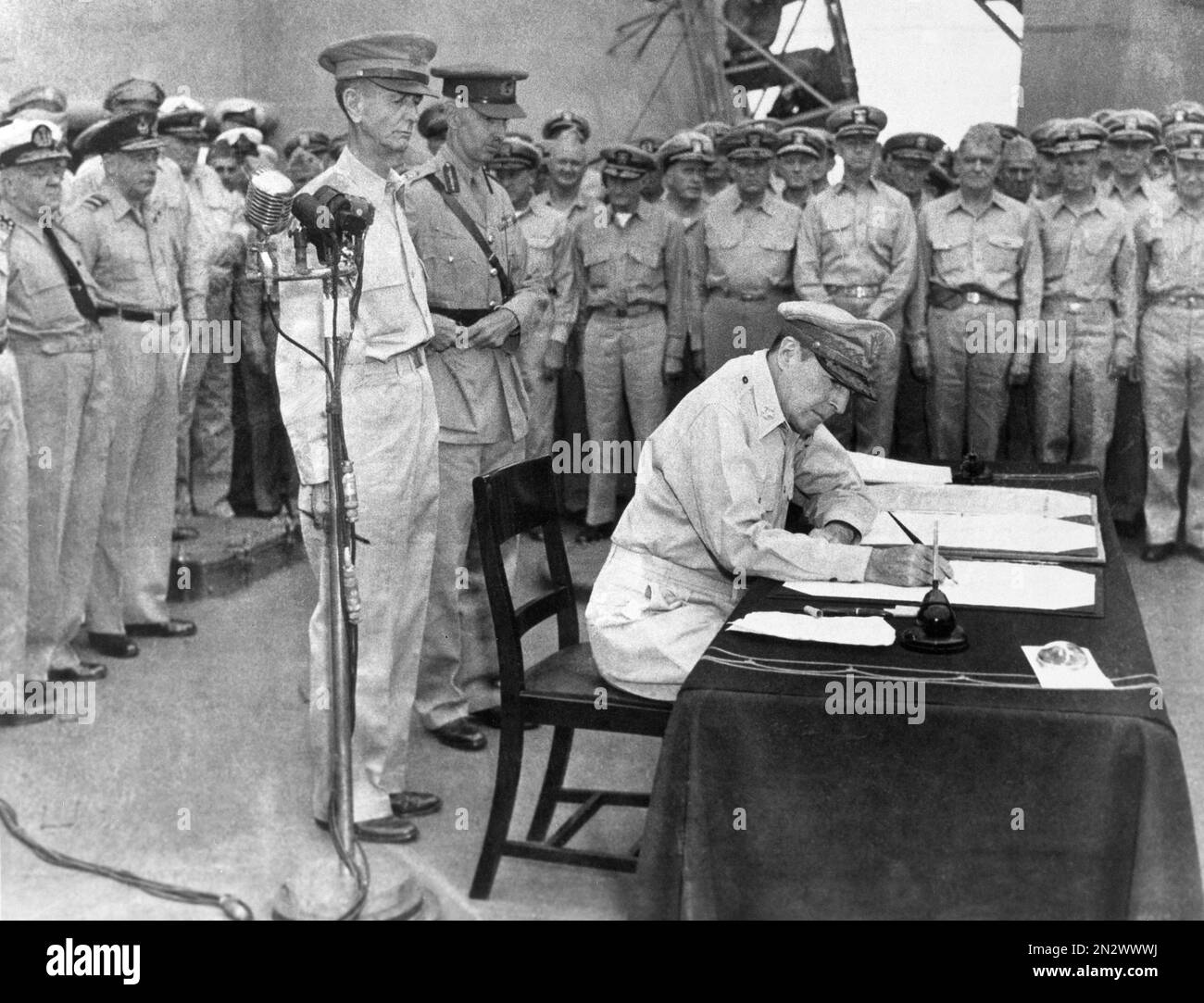U.S. Gen. Douglas MacArthur signs the Japanese surrender documents ...