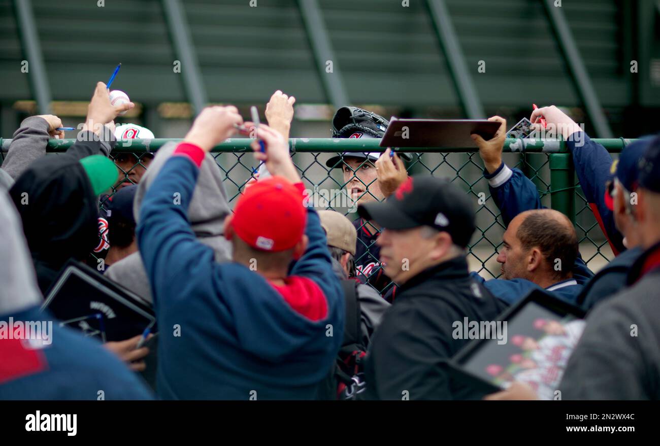 Atlanta Braves pitcher Alex Wood looks through a fence while signing ...