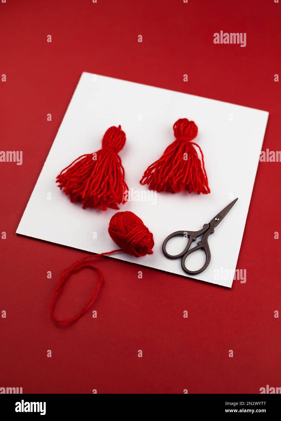 Red tassel Baba Marta symbol Martenitsa on white card. International ...