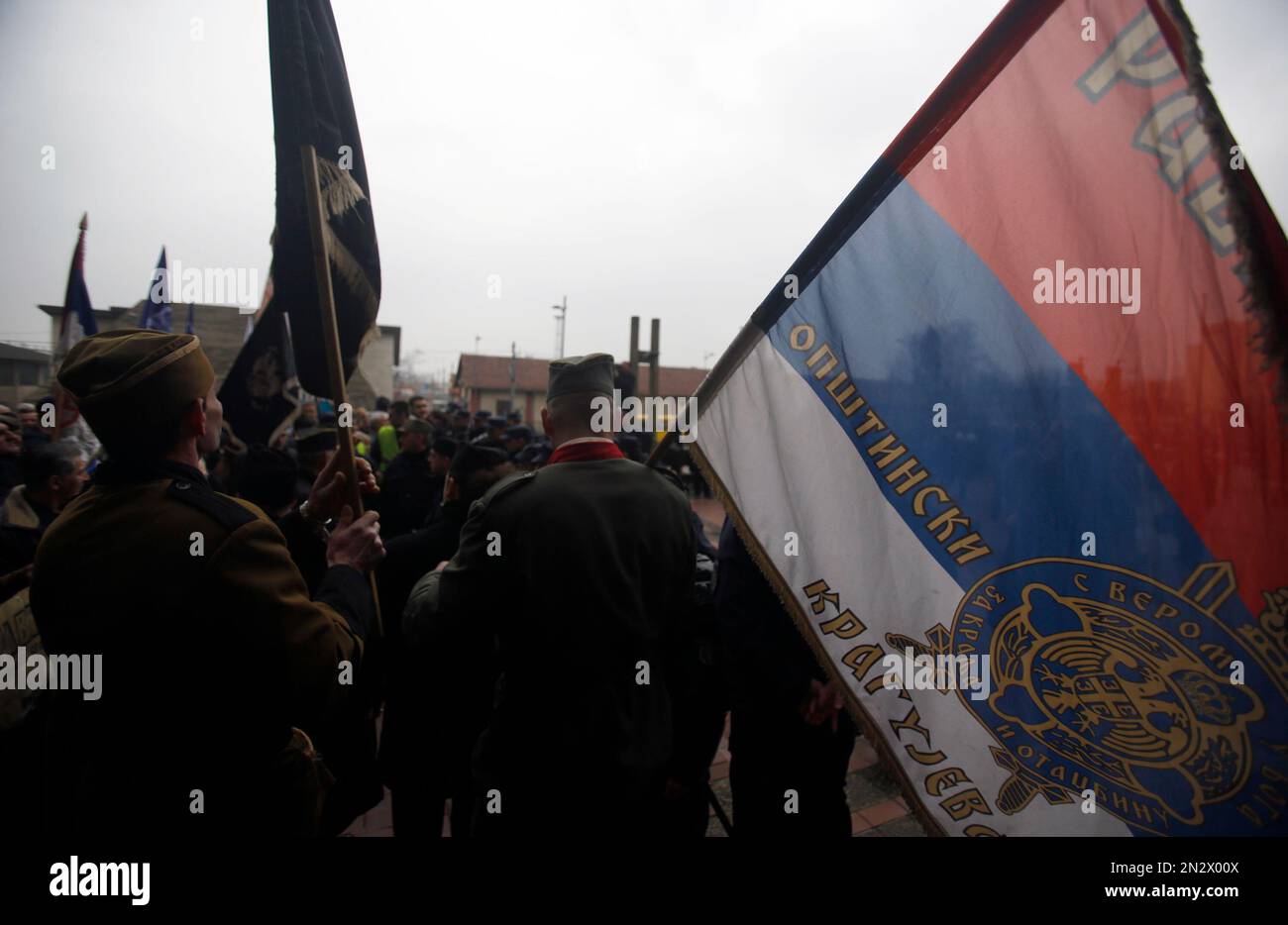 A protester holds a Chetniks flag during protest in front of the Higher ...