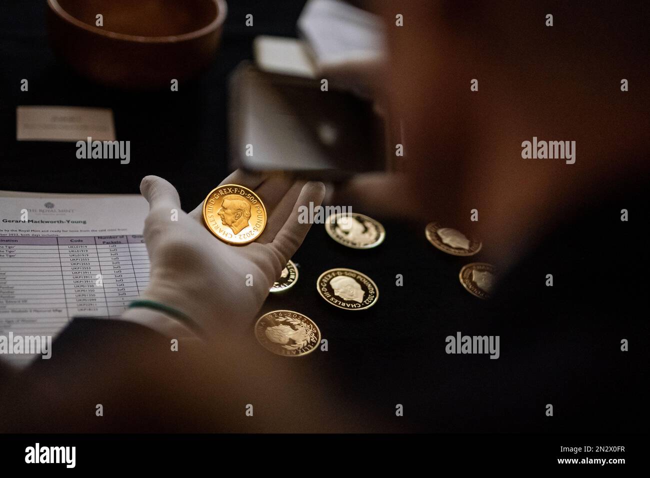 A coin featuring the effigy of King Charles III is assessed at ...