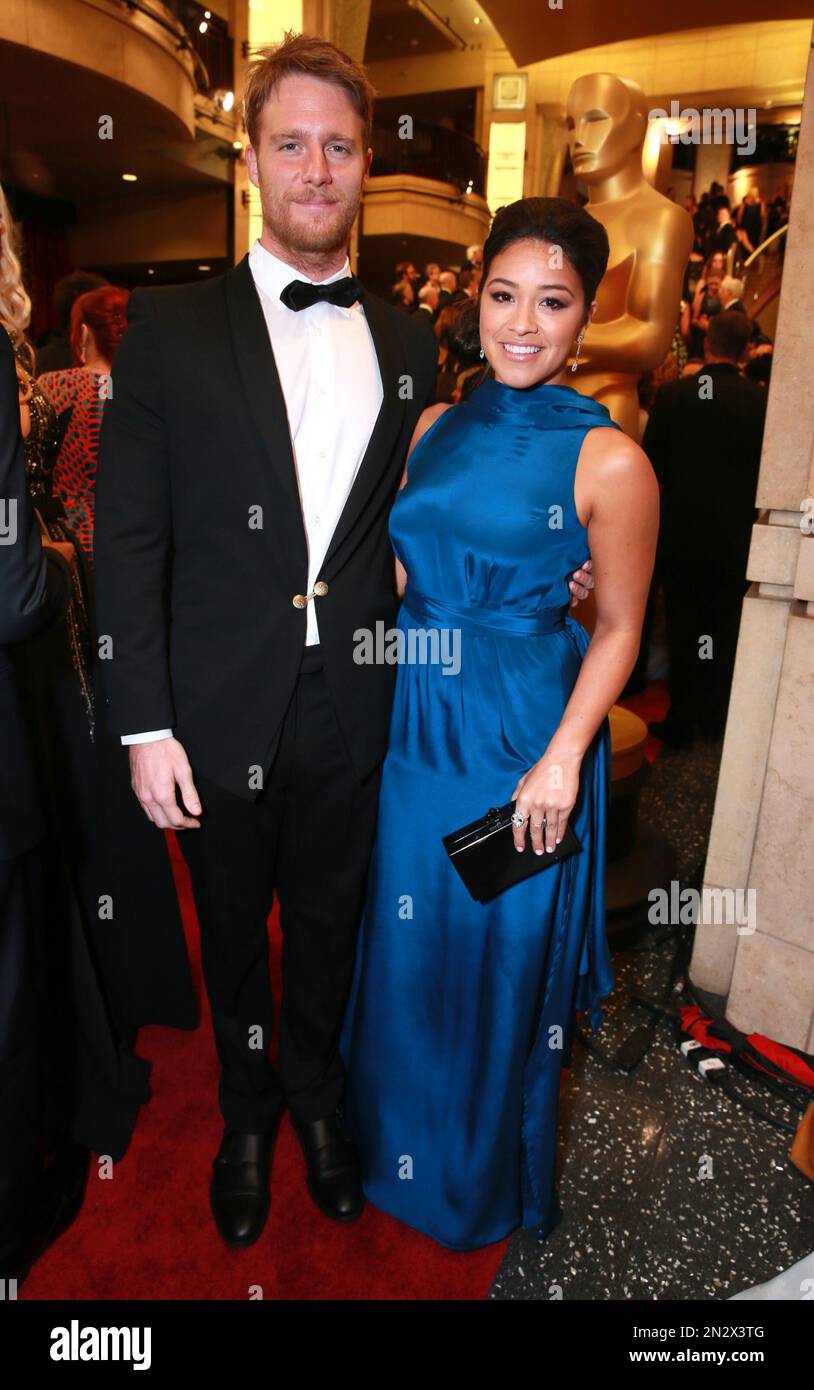 Jake McDorman, left, and Gina Rodriguez arrive at the Oscars on Sunday ...