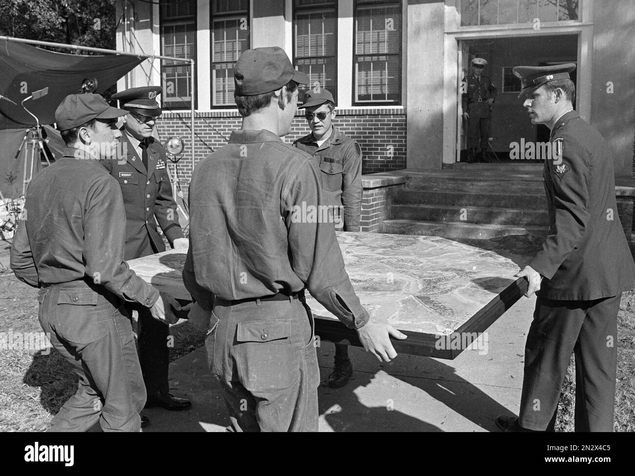 Soldiers at Fort Benning, Ga., carry a large relief map showing the My ...