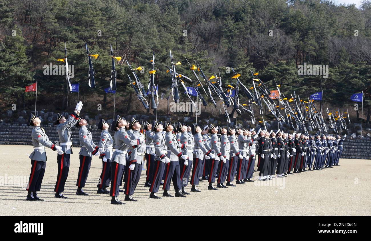 Members of a South Korean honor guard throw their guns in the air after ...