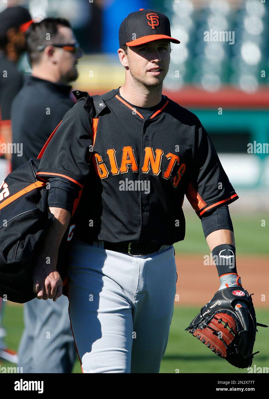 San Francisco Giants' Buster Posey carries his gear prior to batting ...