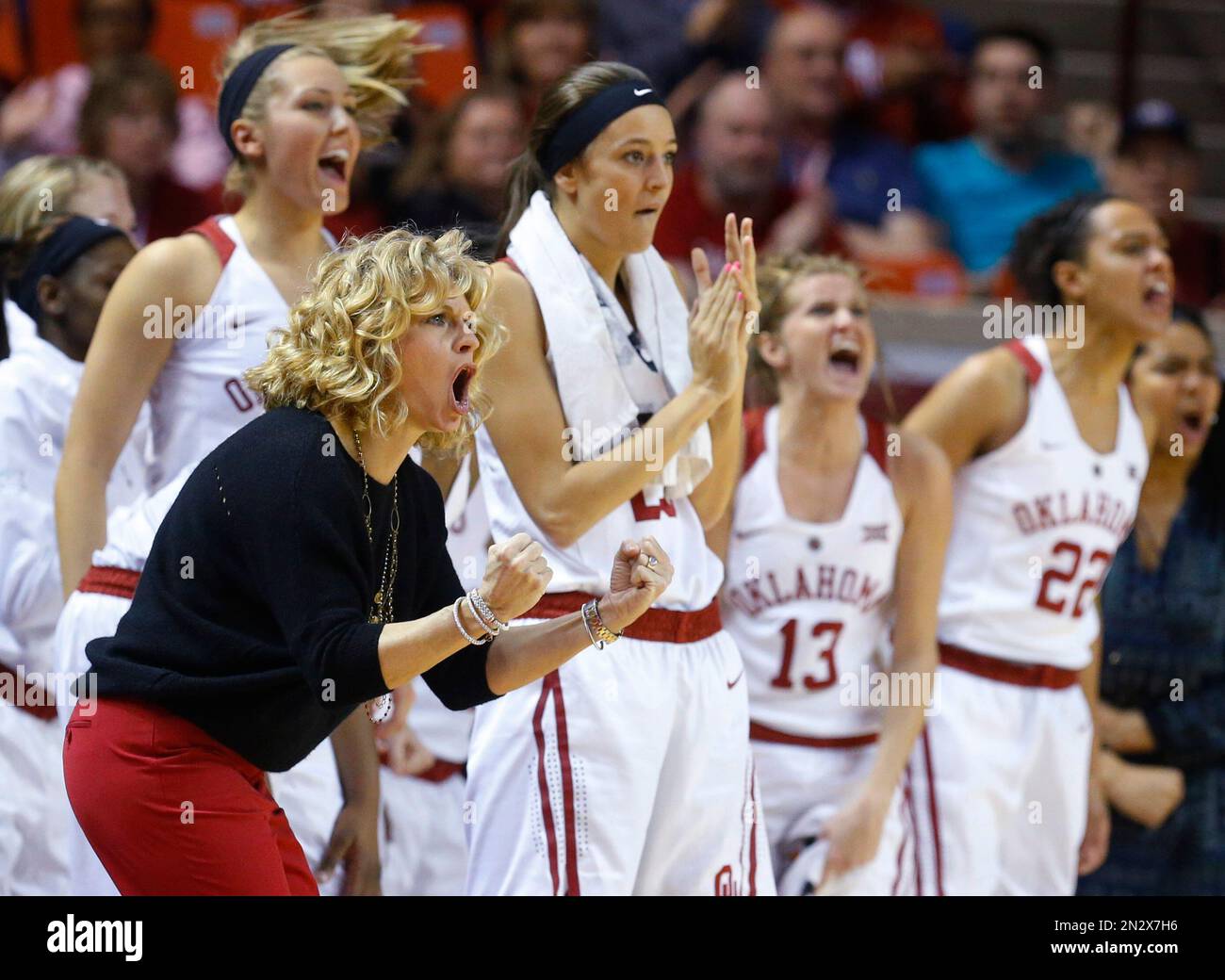 Oklahoma head coach Sherri Coale, left, and players on the bench cheer ...