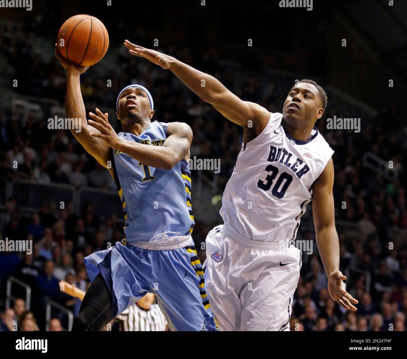 Marquette guard Duane Wilson (1) shoots next to Butler forward Kelan ...