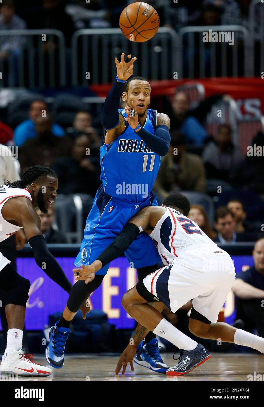 Dallas Mavericks guard Monta Ellis (11) passes between Atlanta Hawks ...