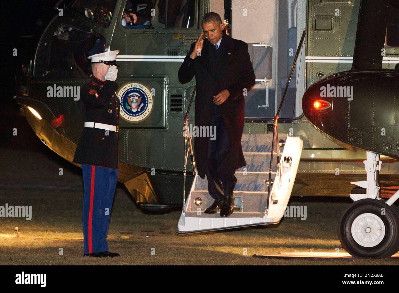 President Barack Obama salutes as he exits the Marine One helicopter on ...