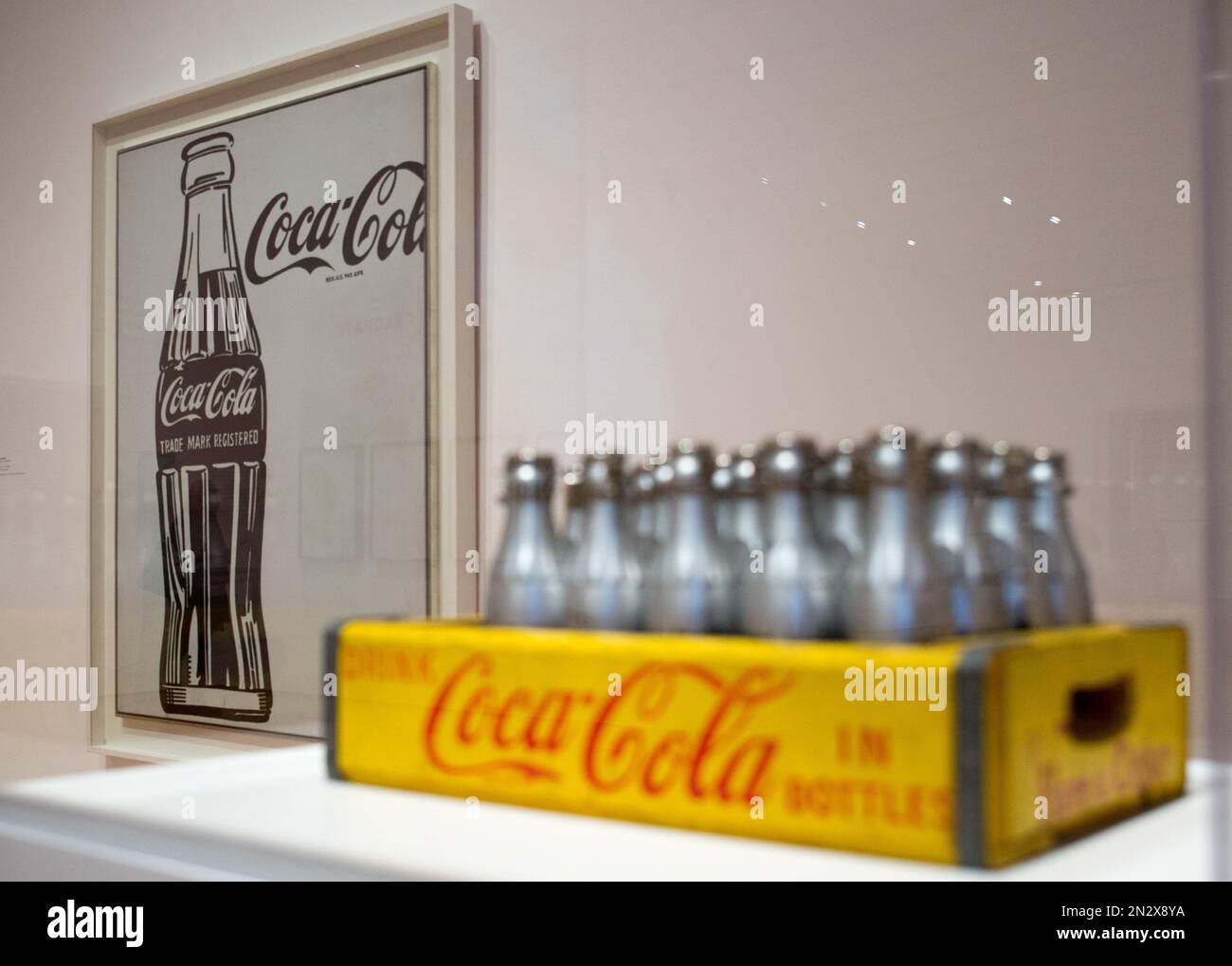 A piece by artist Andy Warhol, left, is displayed next to a case of ...
