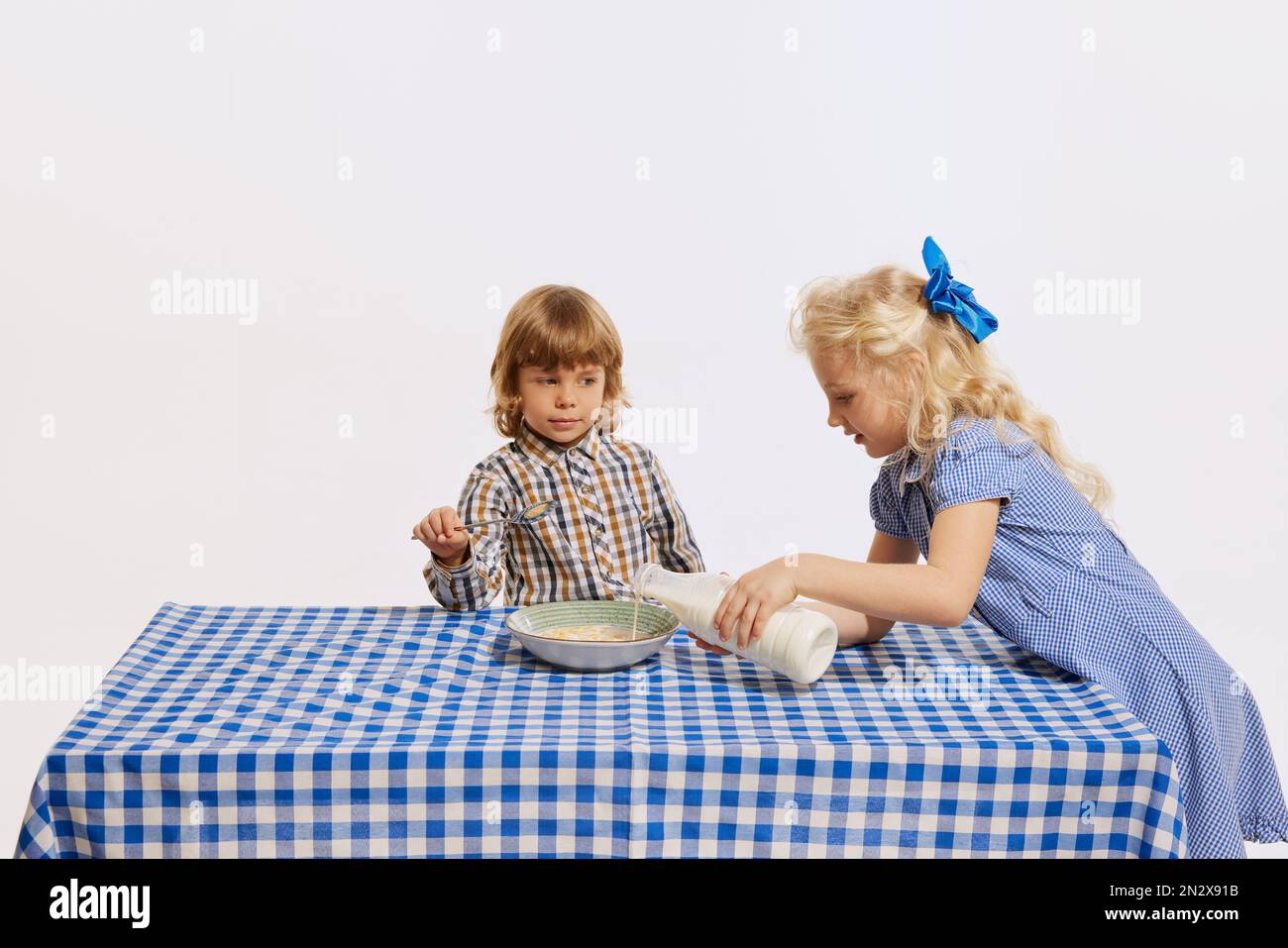 Cute children, kids playing, having fun, tasting corn flakes together ...
