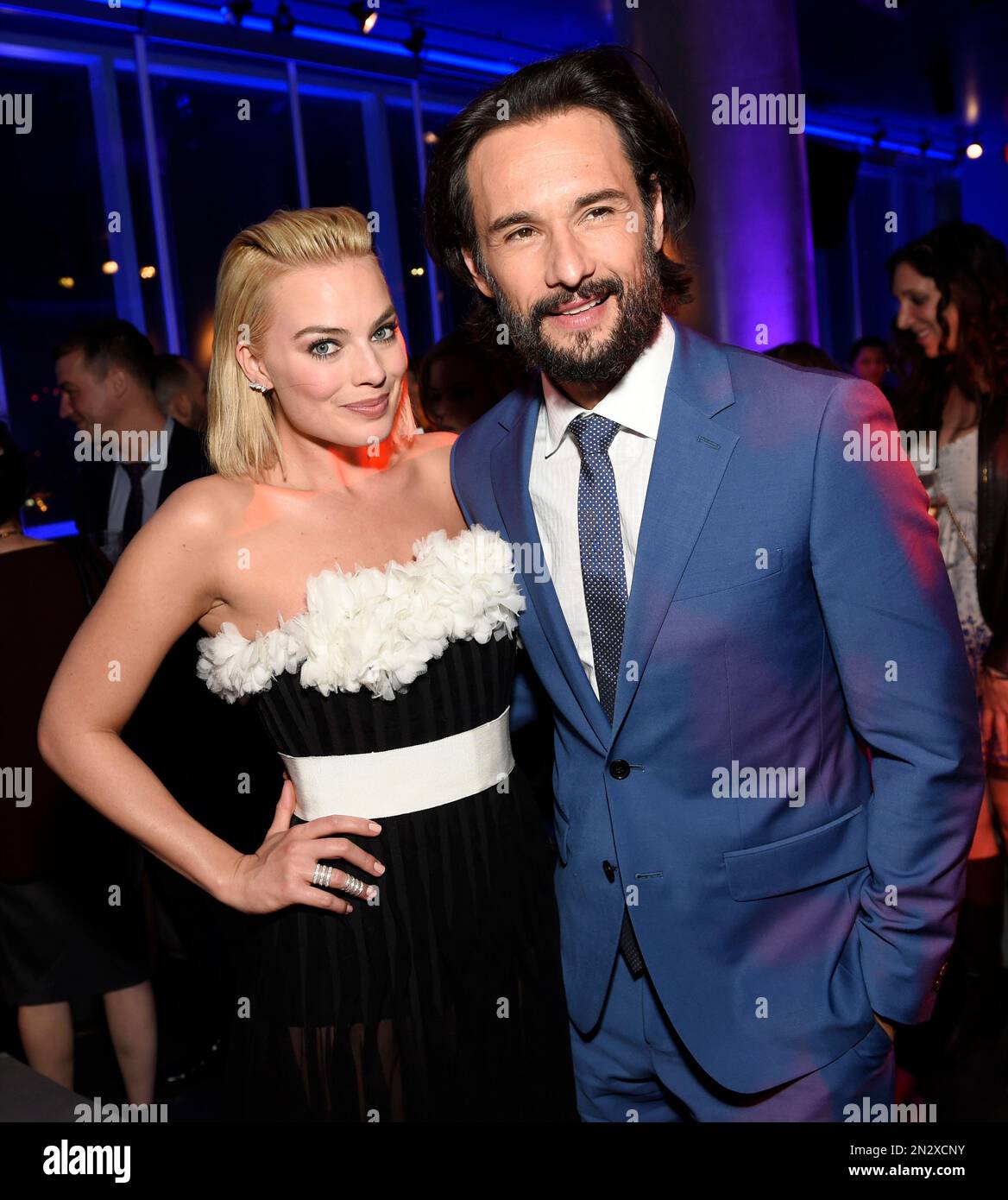 "Focus" cast members Margot Robbie, left, and Rodrigo Santoro pose ...