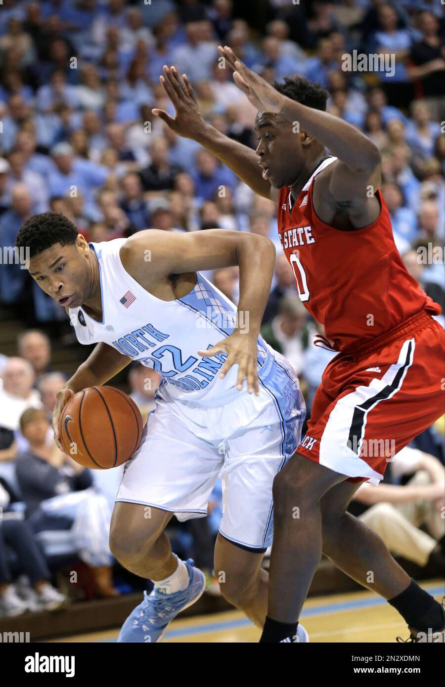 North Carolina's Isaiah Hicks (22) is guarded by North Carolina State's ...
