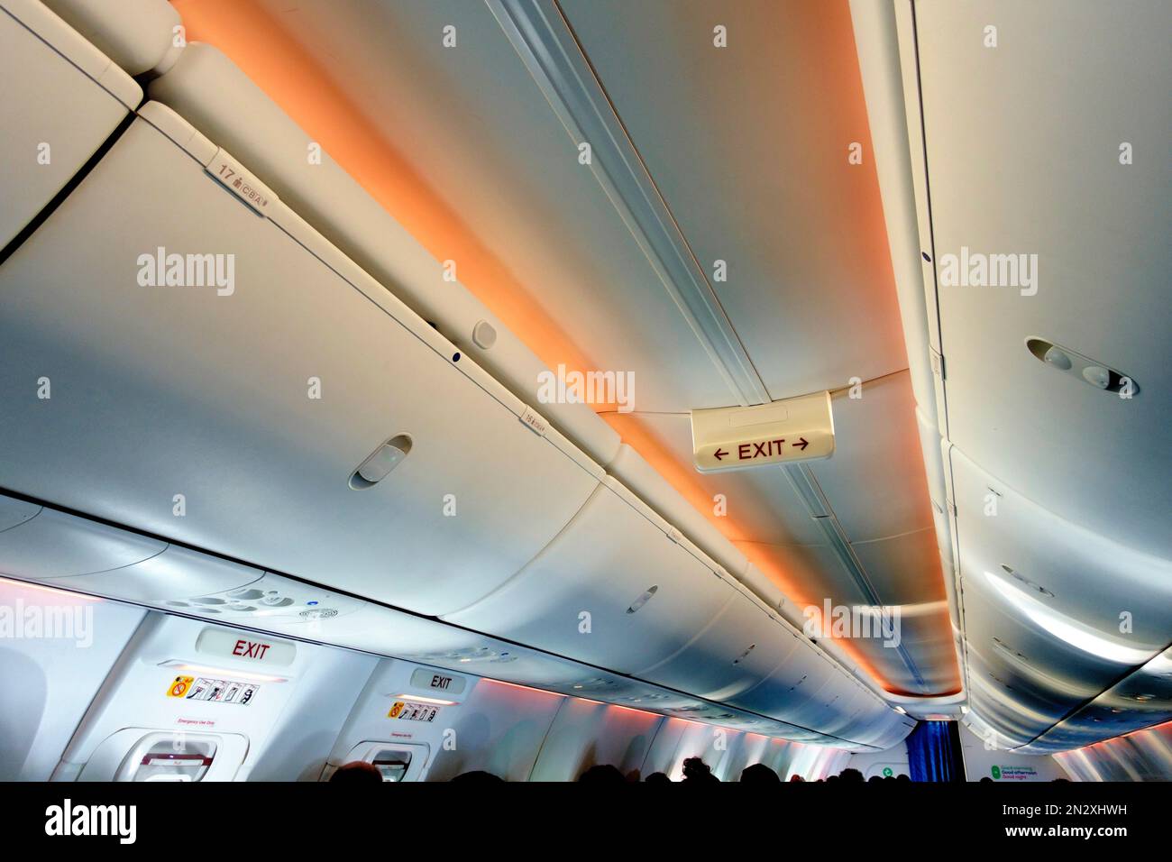 Emergency exit signs in a commercial airplane.Photo without people ...
