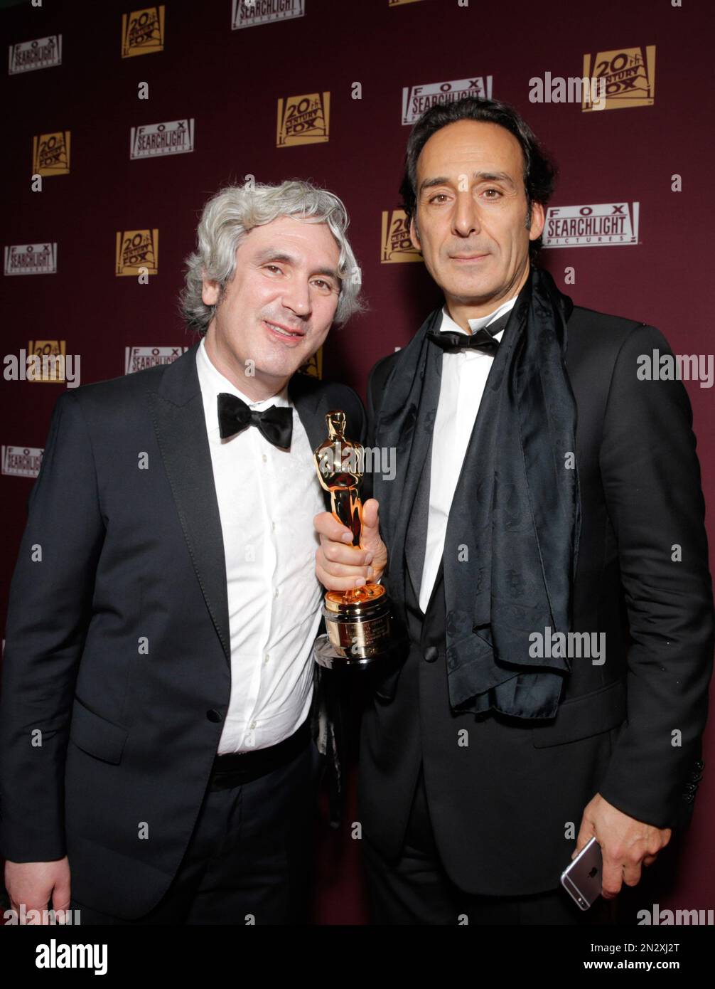 Jeff Sanderson, left, and Alexandre Desplat are seen with his award for ...