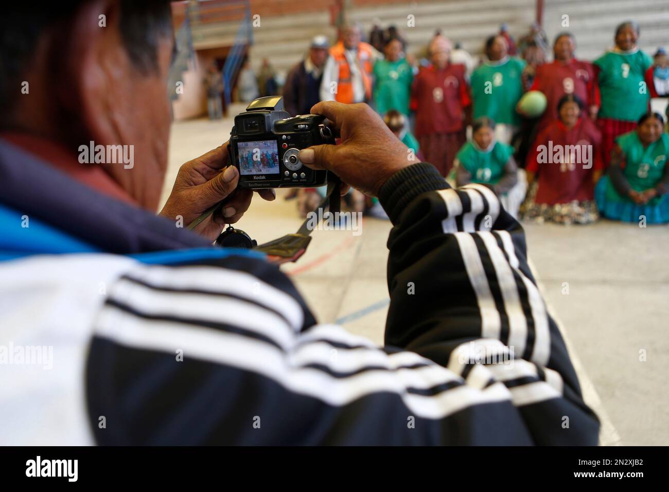 In this Feb. 11, 2105 photo, a photographer takes a group picture of ...