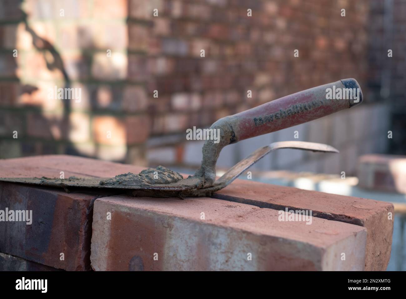 Building site: trowel, bricks and mortar for brickwork, part of a ...