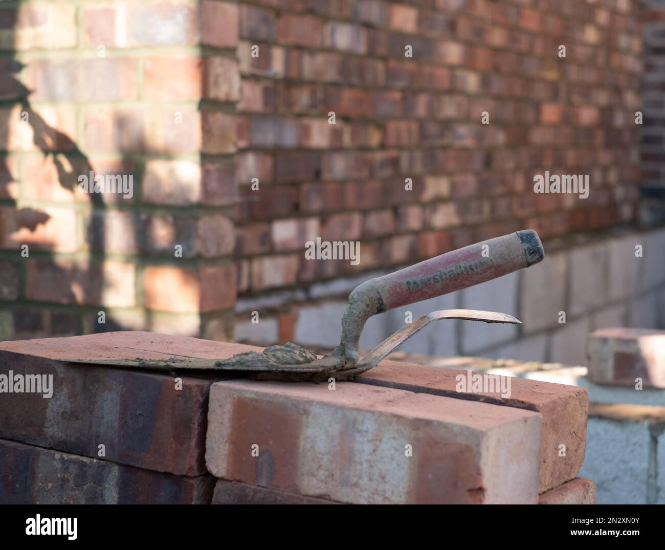 Building site: trowel, bricks and mortar for brickwork, part of a ...