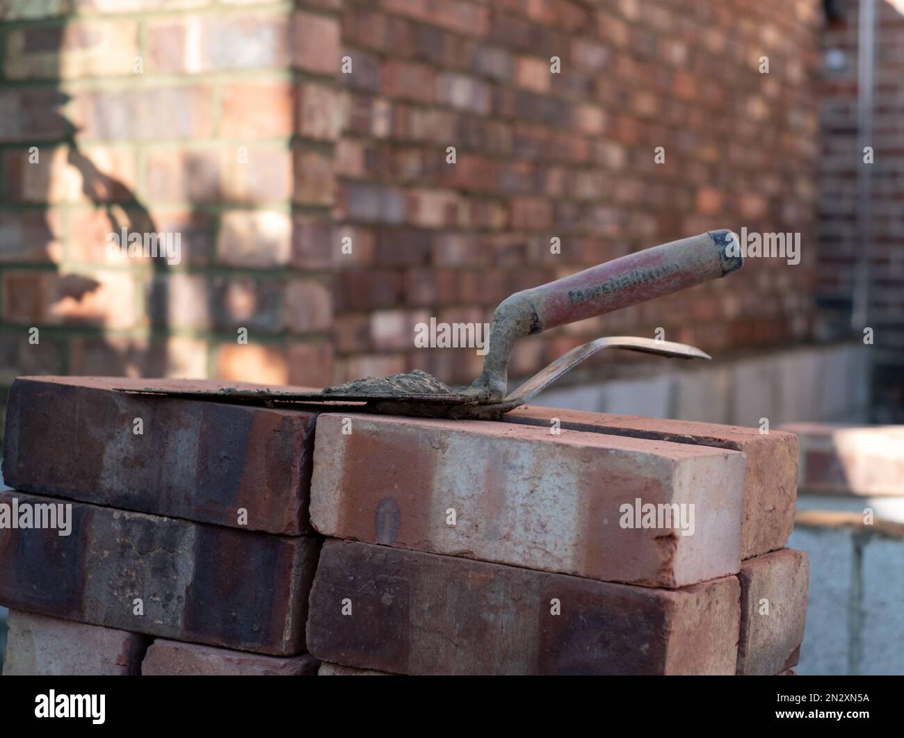 Building site: trowel, bricks and mortar for brickwork, part of a ...