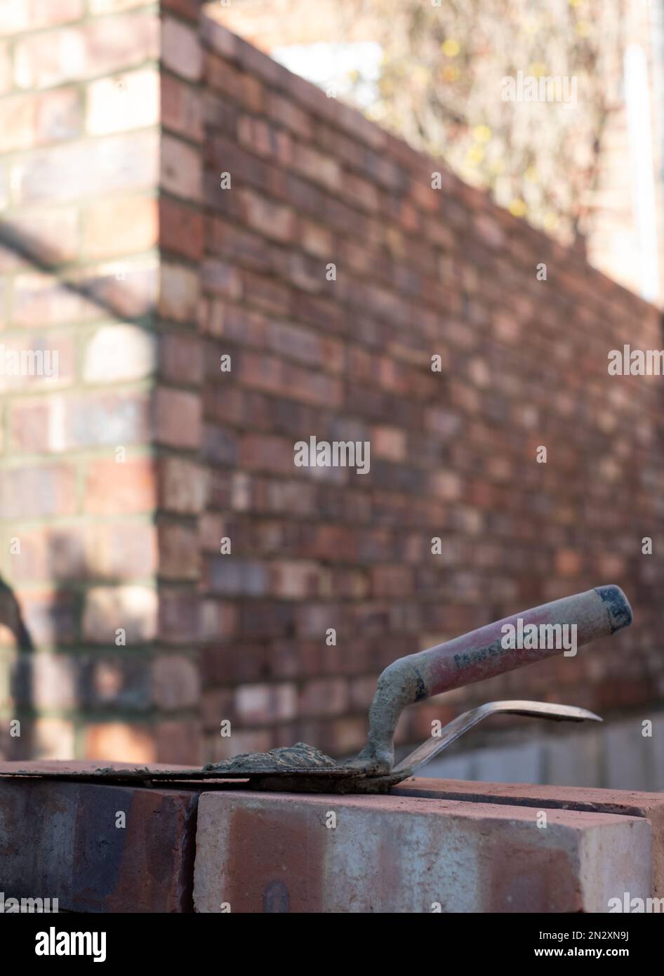 Building site: trowel, bricks and mortar for brickwork, part of a ...
