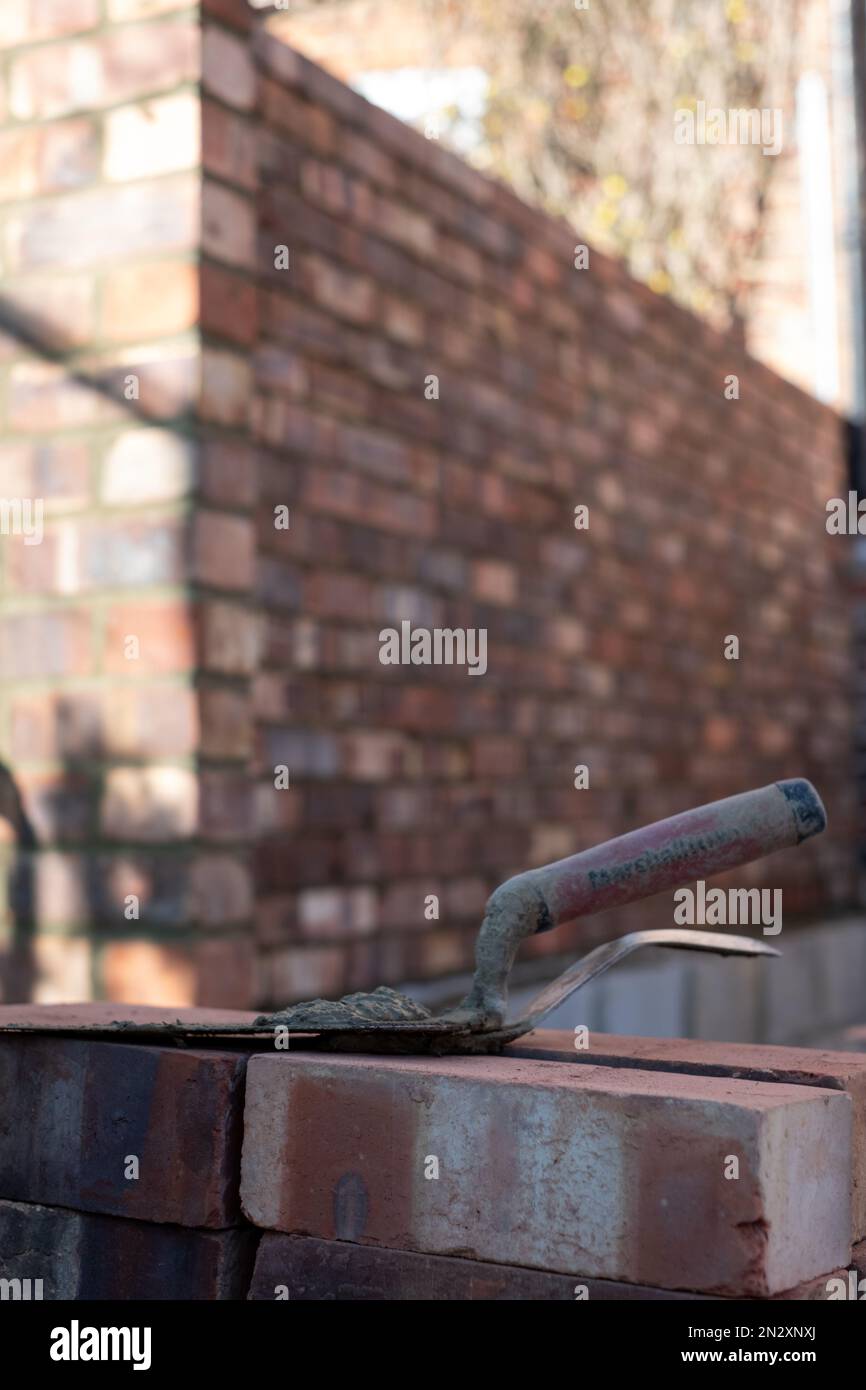 Building site: trowel, bricks and mortar for brickwork, part of a ...