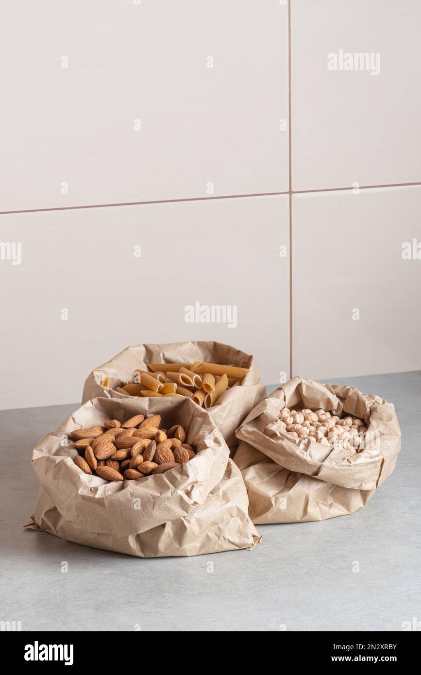 zero waste packaging. Pasta and nuts in paper bags on the table Stock ...