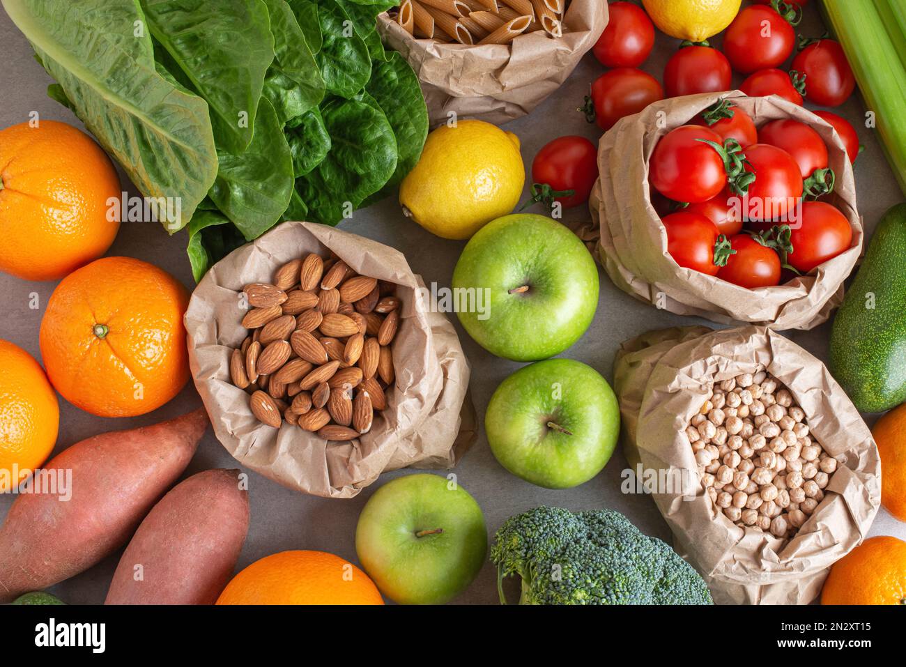 zero waste packaging. Different vegetables and fruits in paper bags on ...