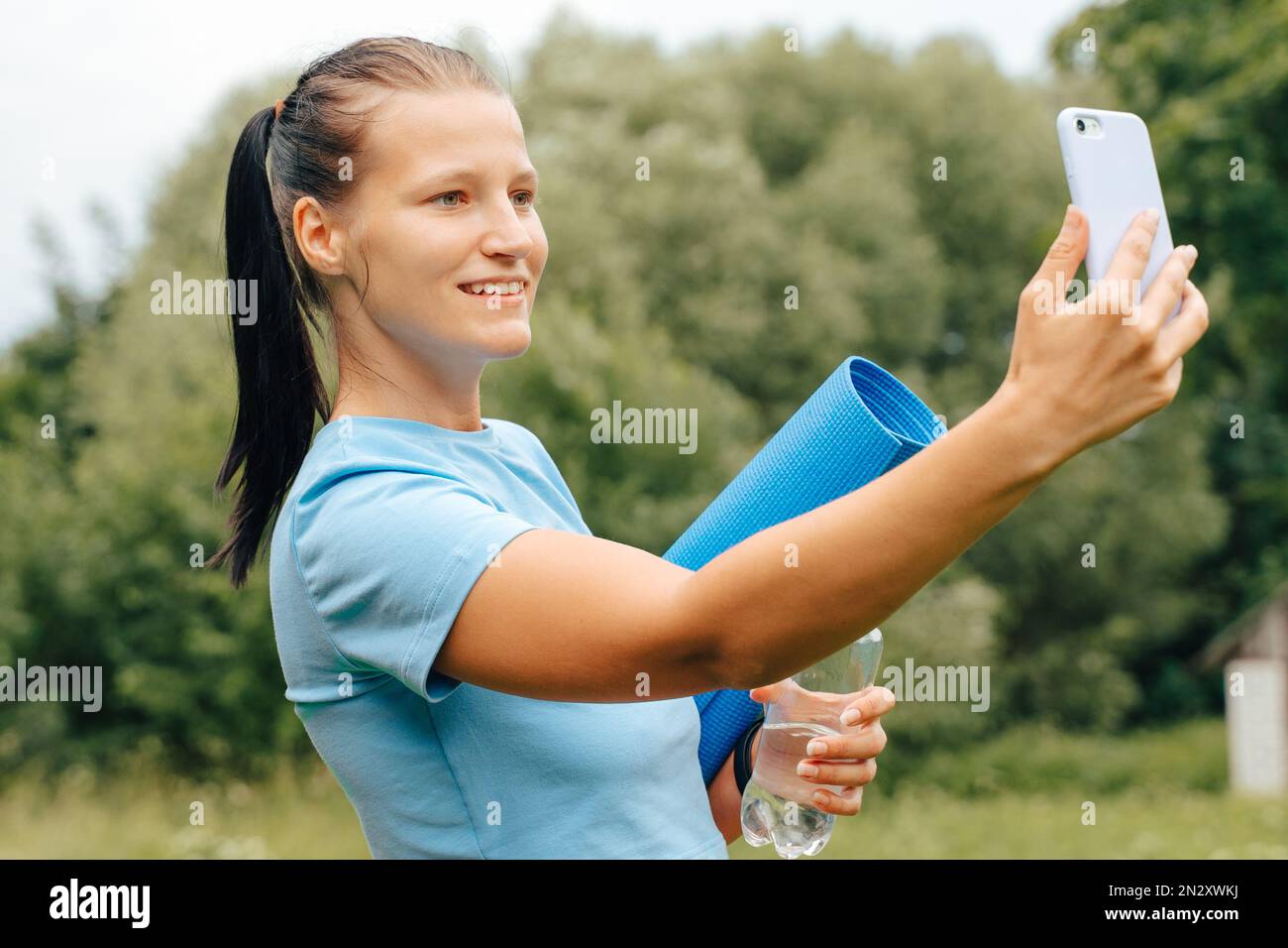 Happy millennial woman runner in sportswear take selfie on mobile phone ...